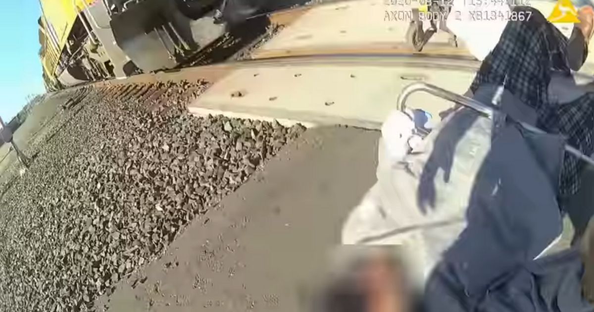 Watch: Police Officer Saves Man in Wheelchair Stuck on Tracks Seconds ...