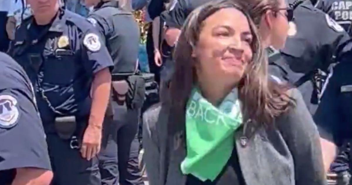 AOC Smirks as She Is Arrested by Capitol Police Outside Supreme Court